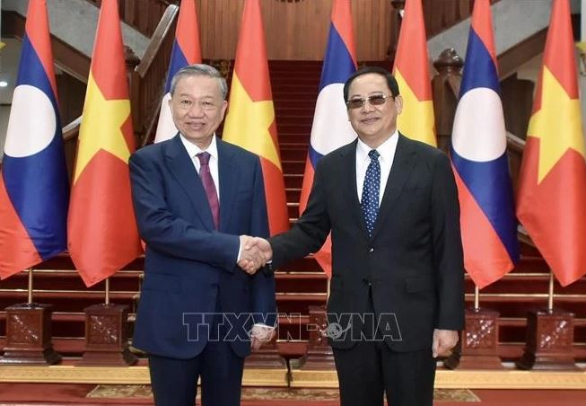 President To Lam meets Lao Prime Minister